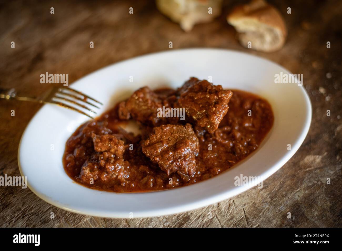 Viennese juice goulash, kaiser roll Stock Photo - Alamy