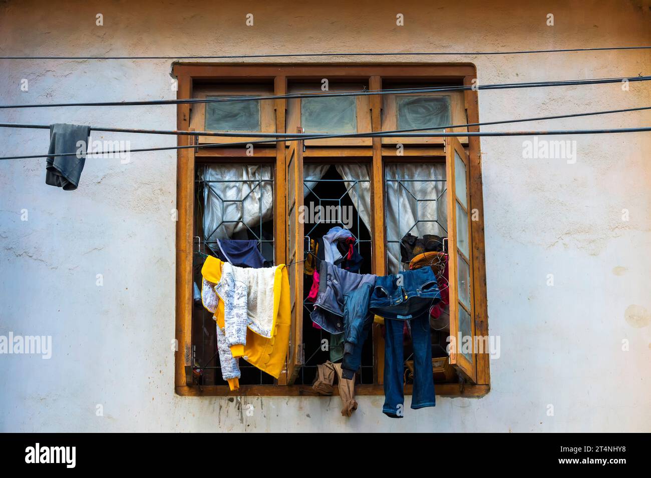 Washed clothes hanging at a window for drying, Kohima, Nagaland, India ...
