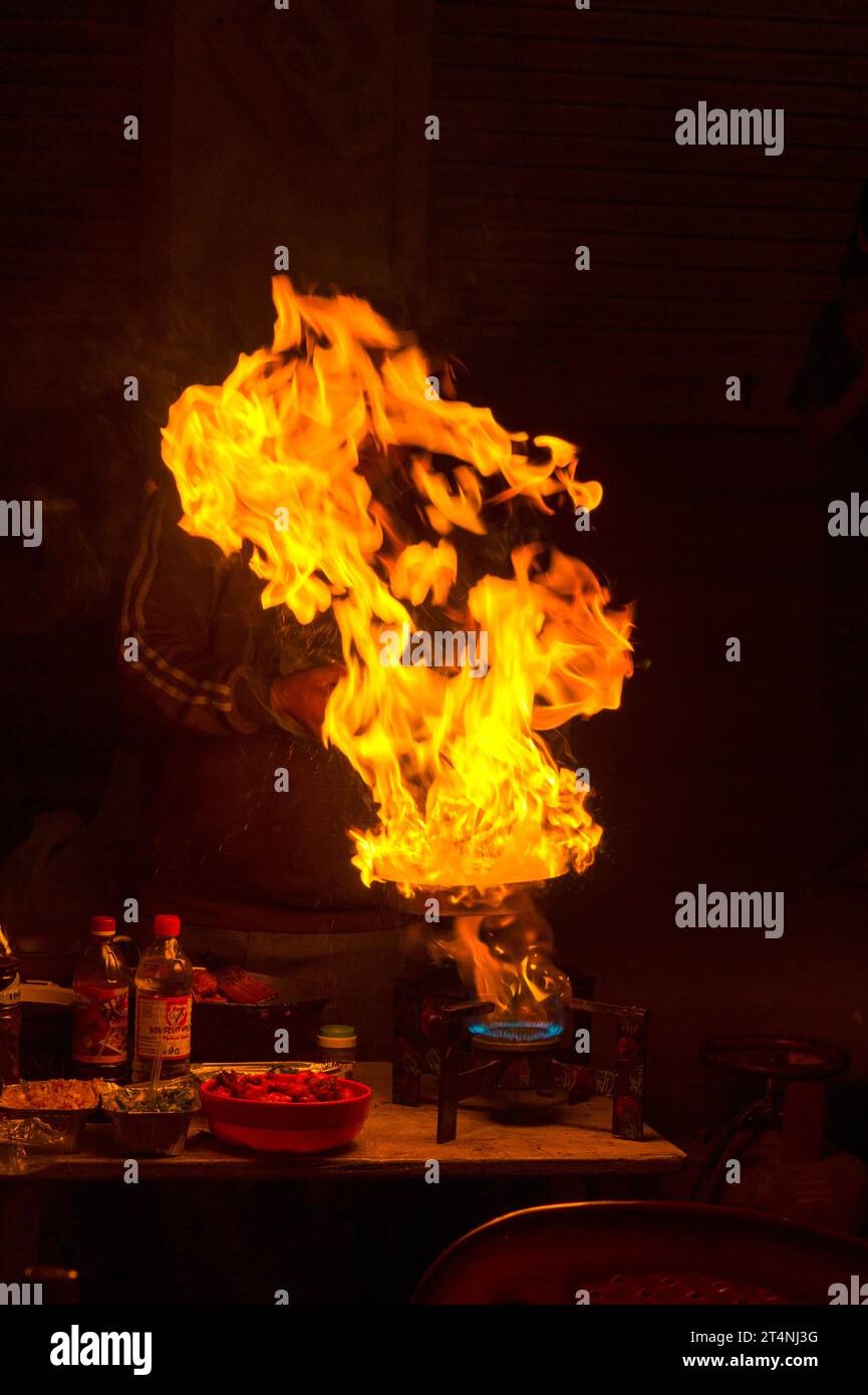 Indian Man flaming food, Night market, Kohima, Nagaland, India Stock ...