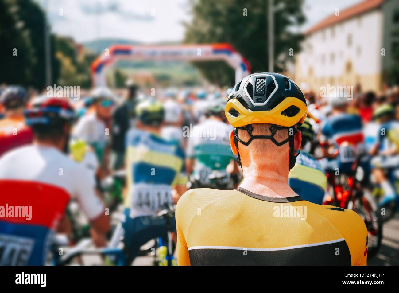 Start of the cycling race. Athlete standing on the start with other ...