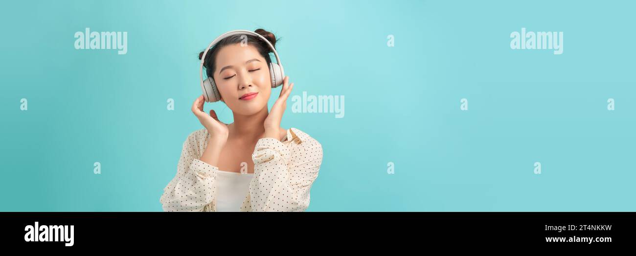 Happy excited girl wearing wireless headphones, listening to music ...