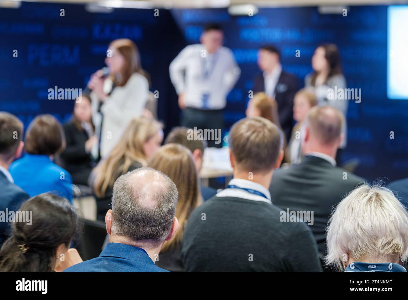 Back view of business partners attending meeting in conference room at ...