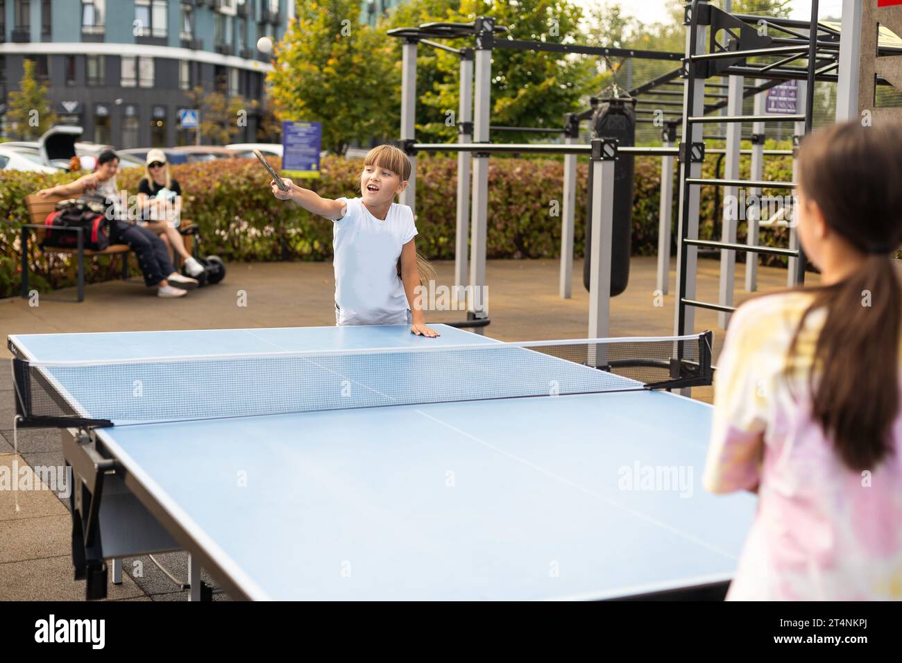 little girl playing table tennis in the tennis hall, tennis racket ...