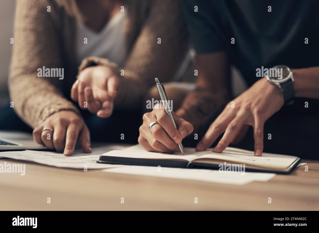 Managing joint finances is a team effort. a couple going over paperwork ...