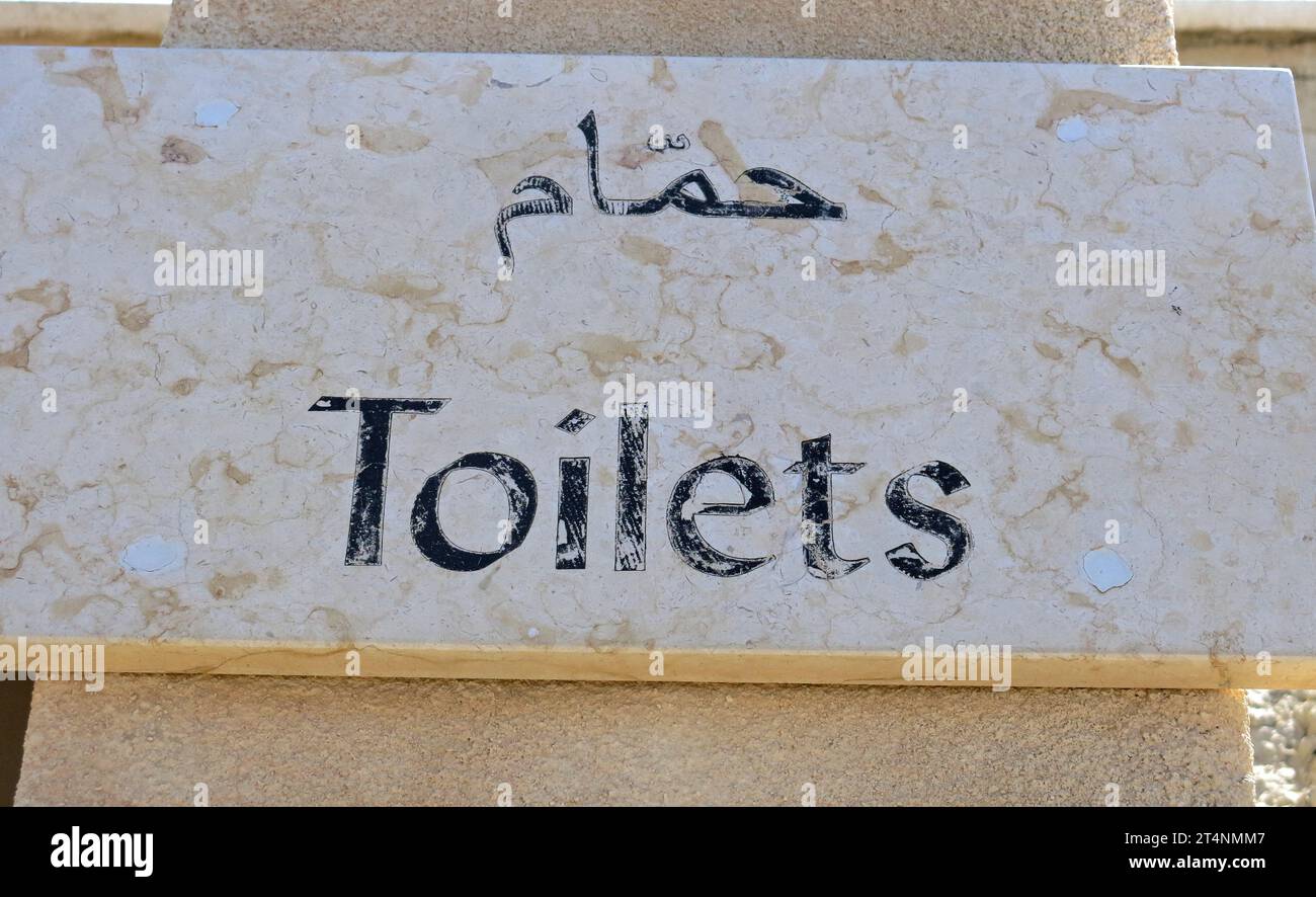 Big Bilingual text in Arabic and English indicating the Toilets Stock ...