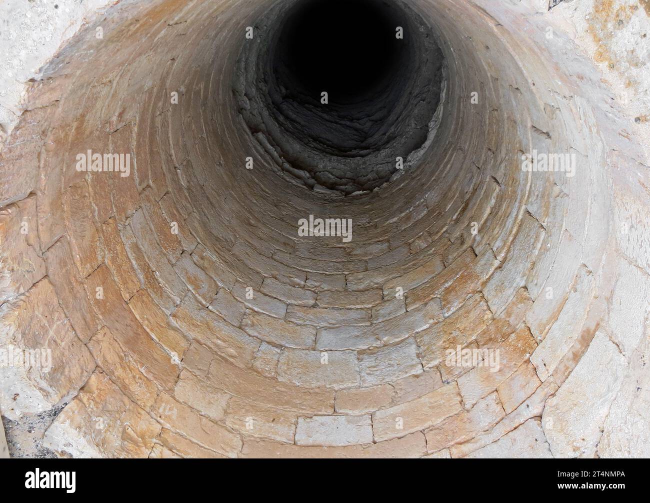 narrow tunnel or a bottomless pit made of rocks and stones Stock Photo ...