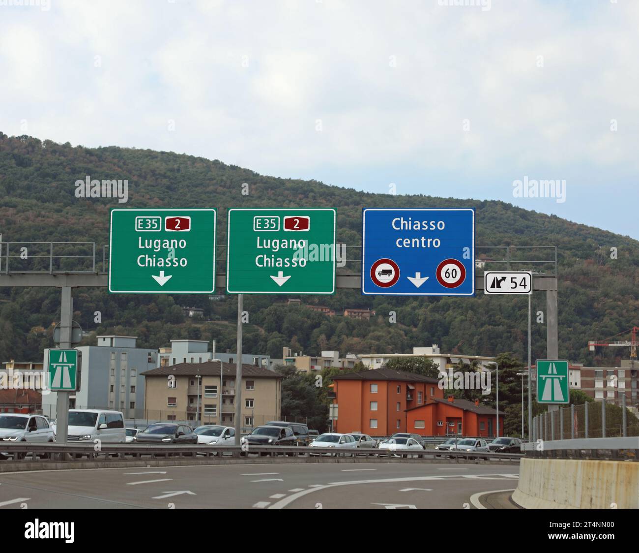 road signs for the cities of CHIASSO and Lugano near the border between ...