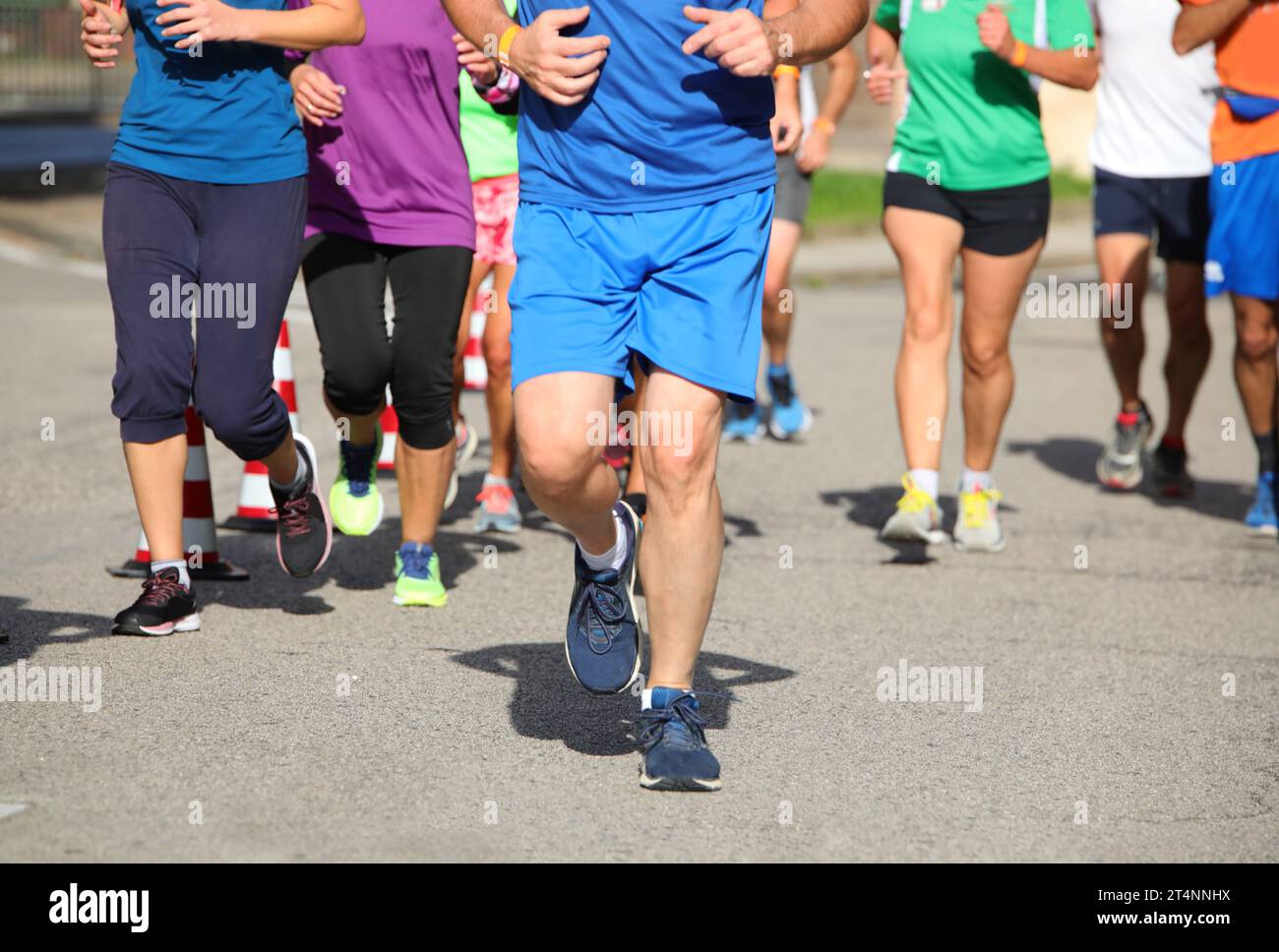 People during foot race running down the street in city wearing ...