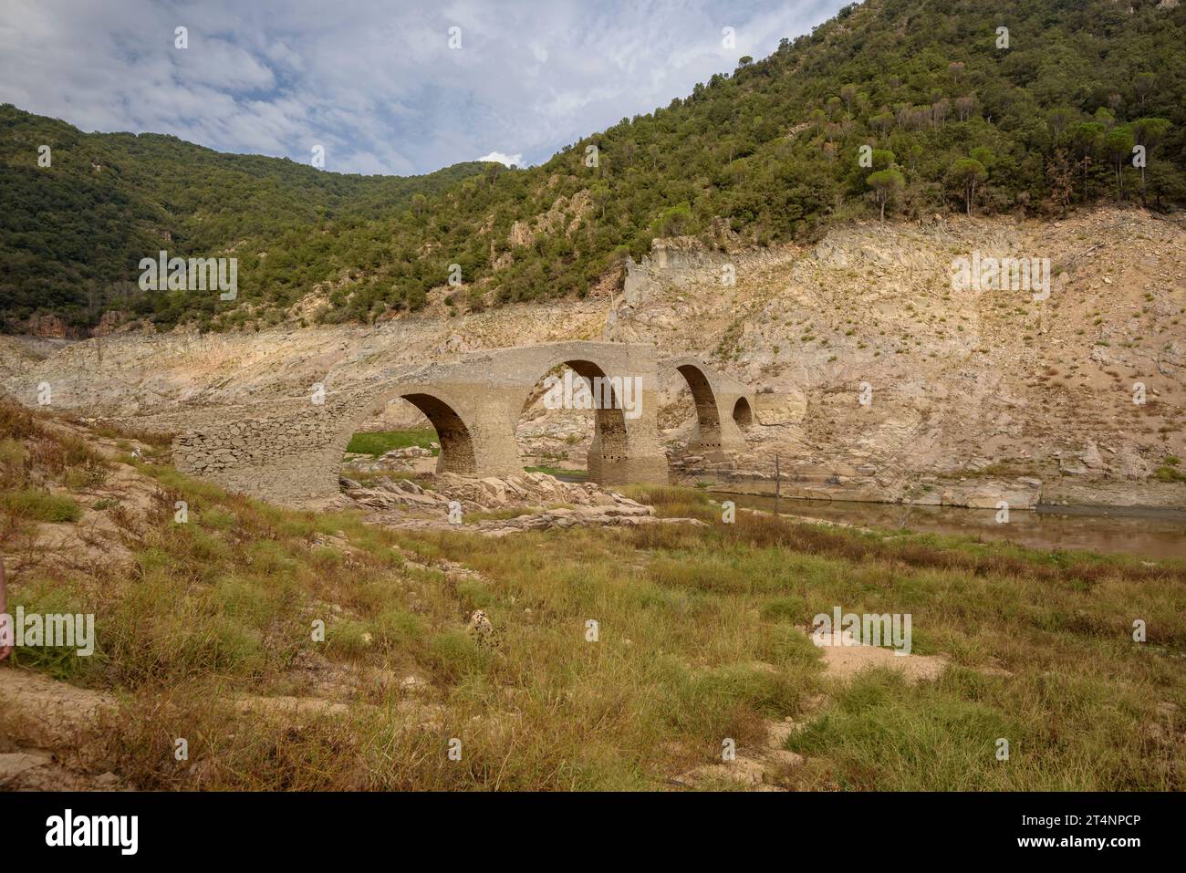 Querós Bridge, an old medieval bridge submerged under the water of the ...