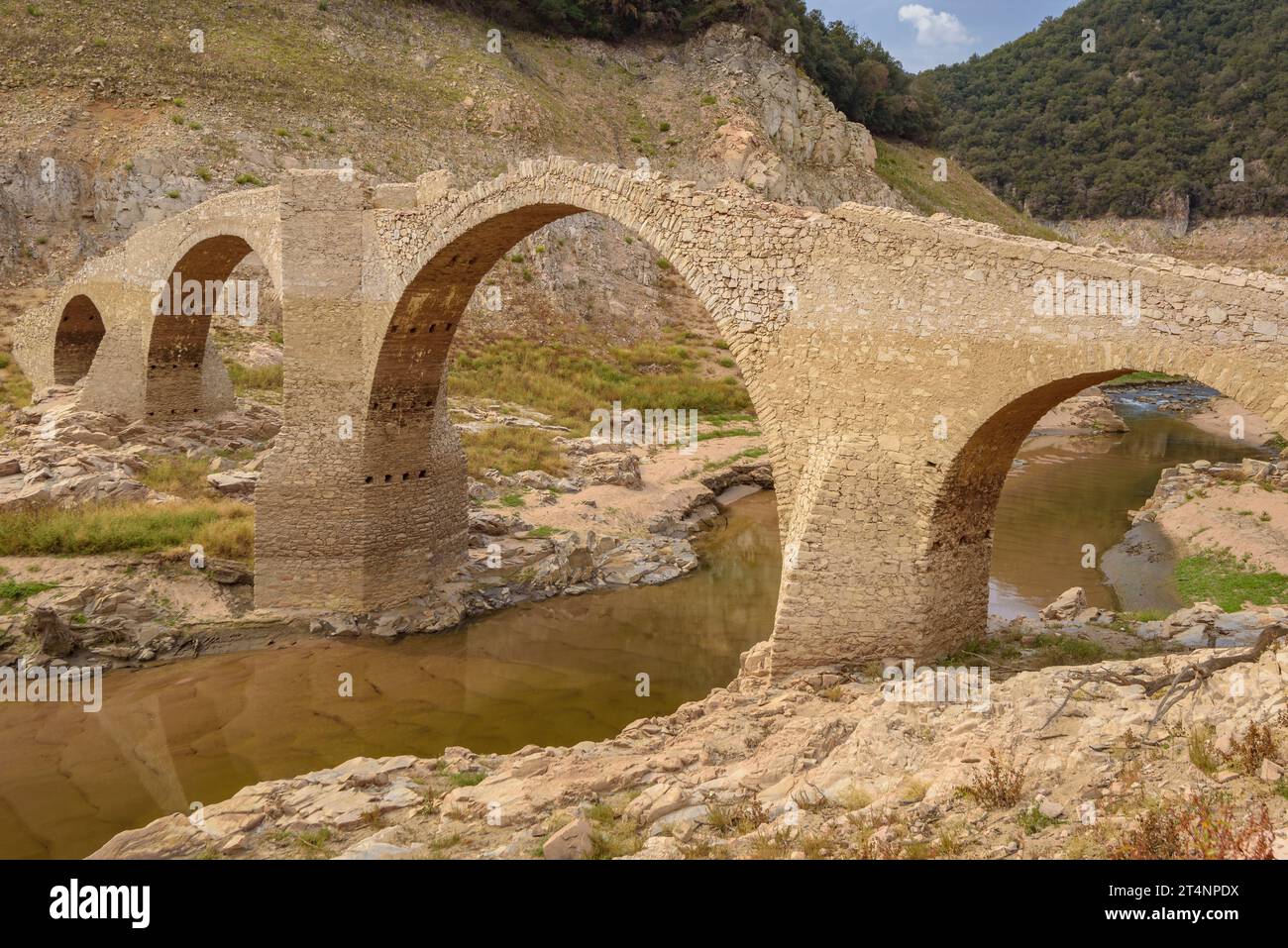 Querós Bridge, an old medieval bridge submerged under the water of the ...