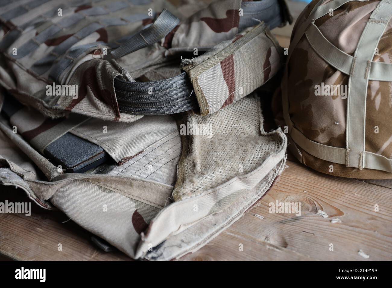 A military helmet of a Ukrainian soldier with a heavy bulletproof vest ...