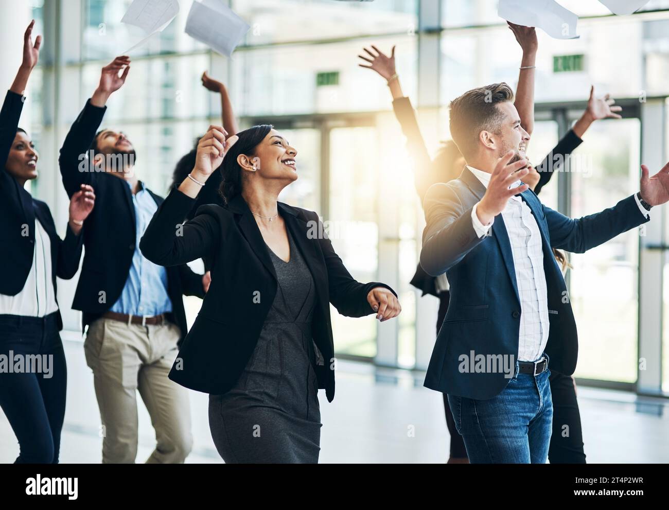 We are a fun bunch. a group of cheerful businesspeople lifting their ...