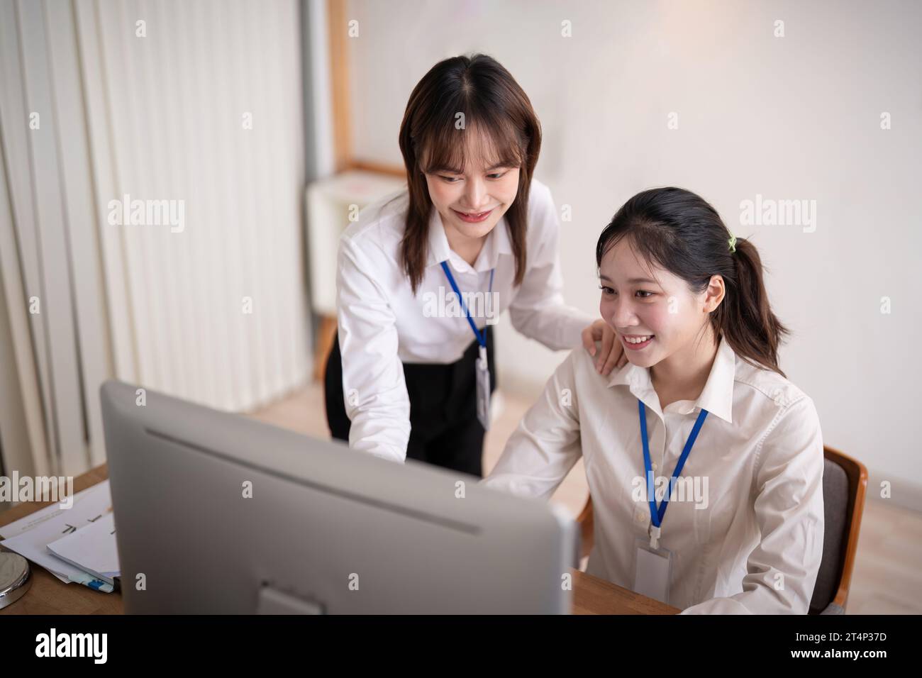 Asian company employee and colleague work together in the office. by ...
