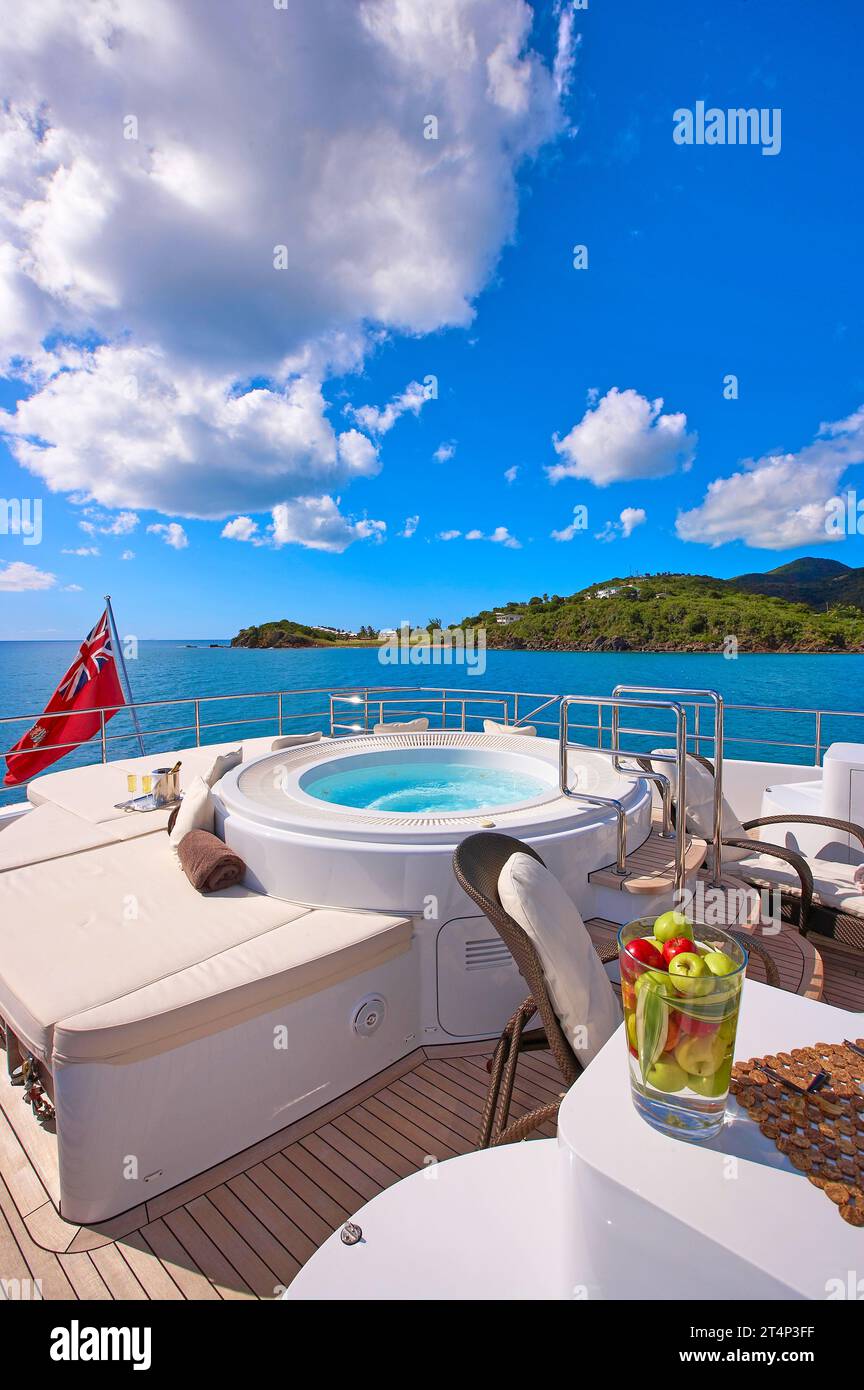 Jacuzzi on sundeck of luxury motoryacht with champagne and views of ...