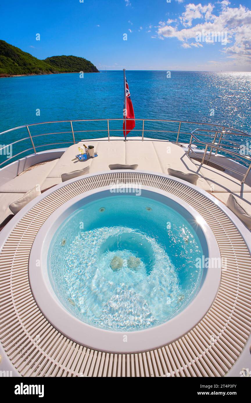 Jacuzzi on sundeck of luxury motoryacht with champagne and views of ...