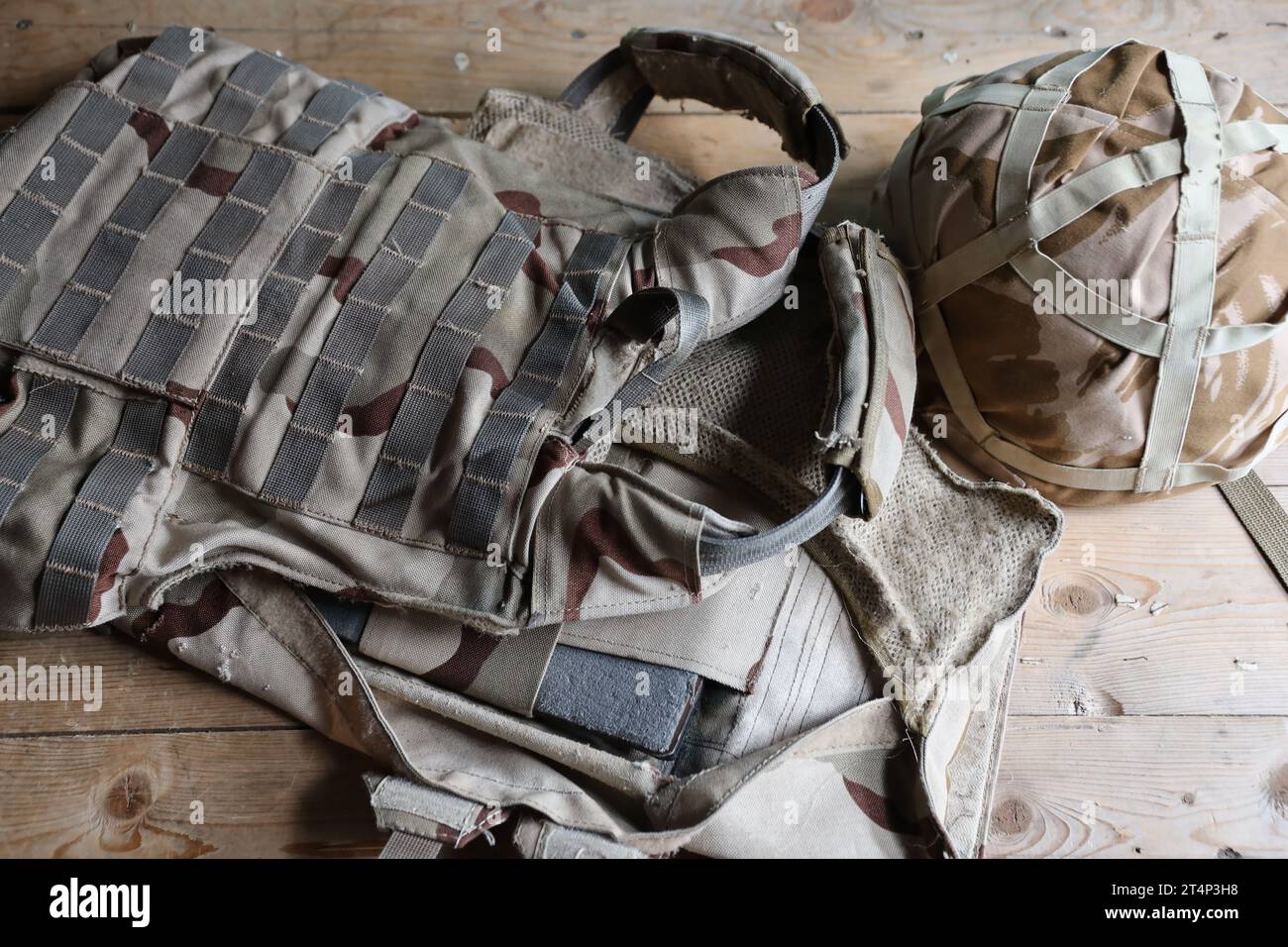 A military helmet of a Ukrainian soldier with a heavy bulletproof vest ...