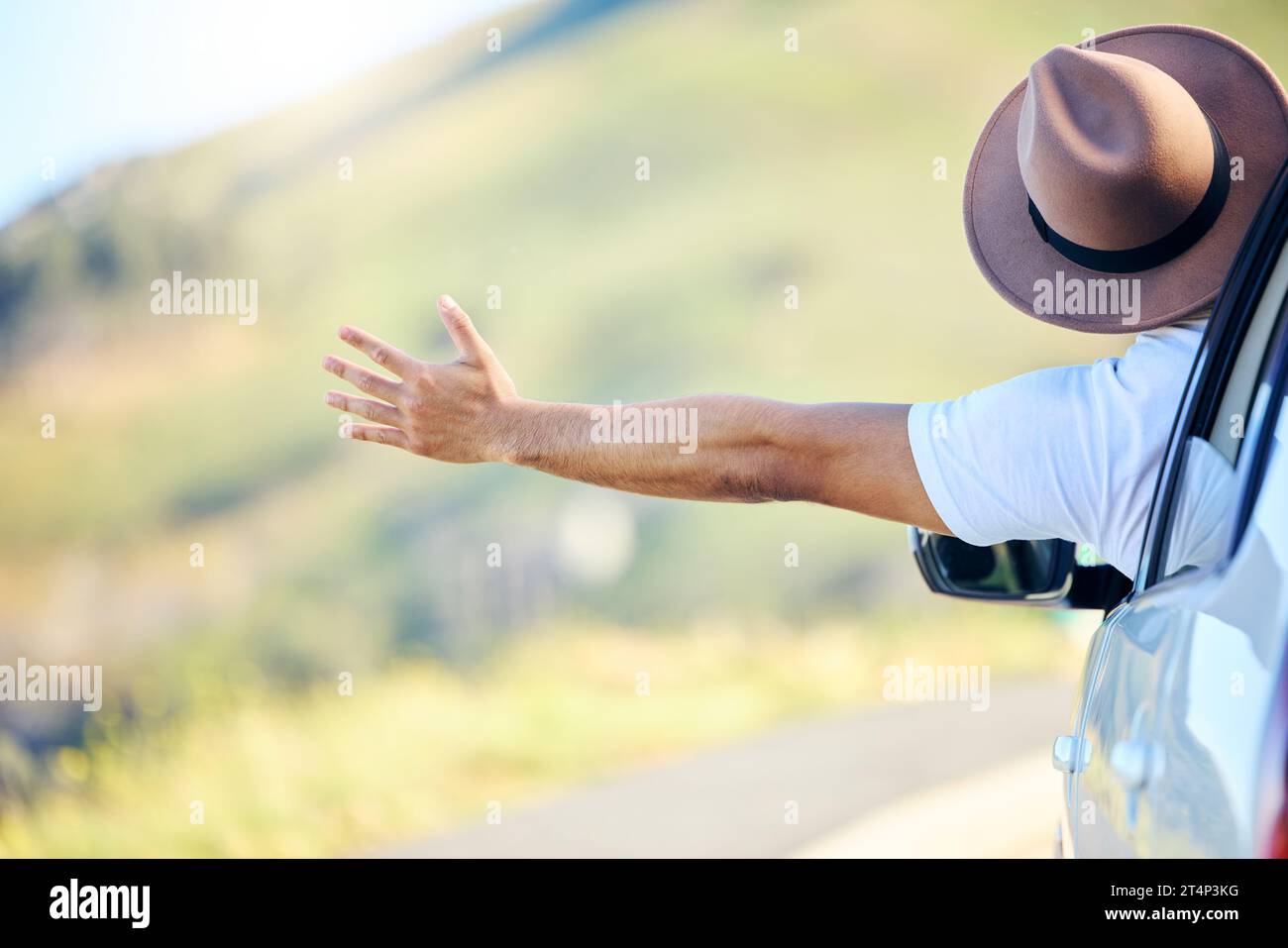 The open road is a beckoning. a unrecognizable man enjoying an ...