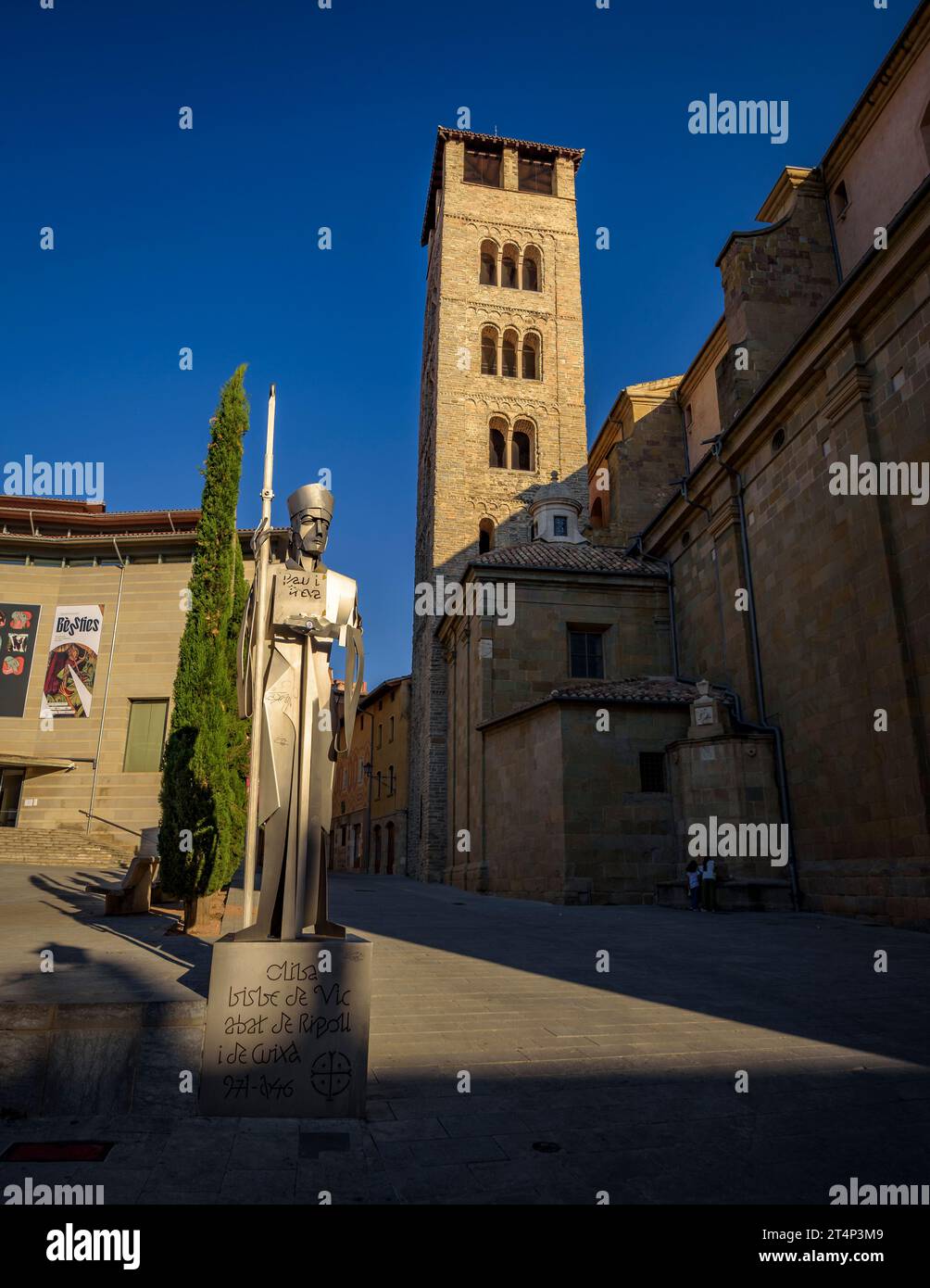 Sculpture of Abbot Oliba in front of the Romanesque bell tower of the ...
