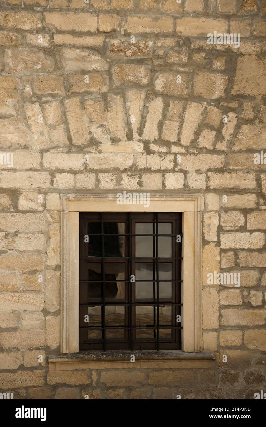 Very old window in brick stone wall of castle or fortress of 18th ...