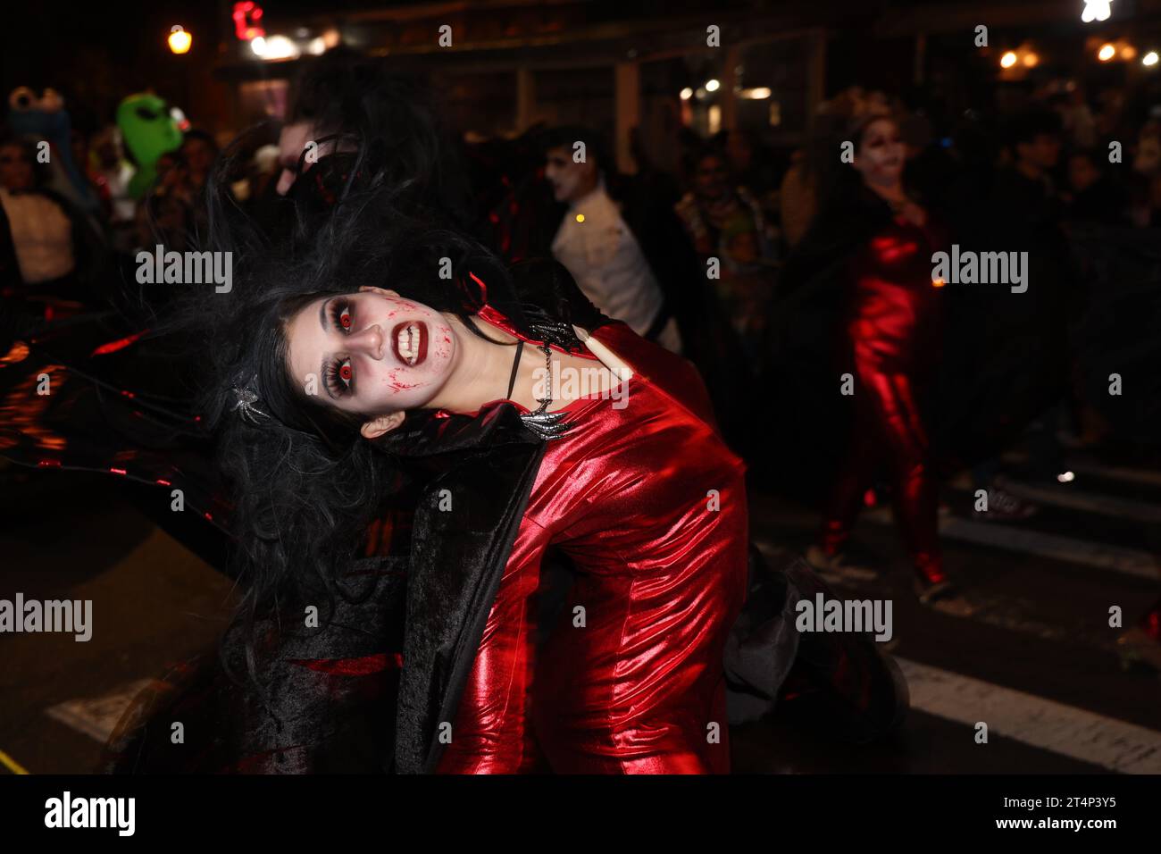 A performer from San Antonio shows her moves from Los Vampiros performs ...