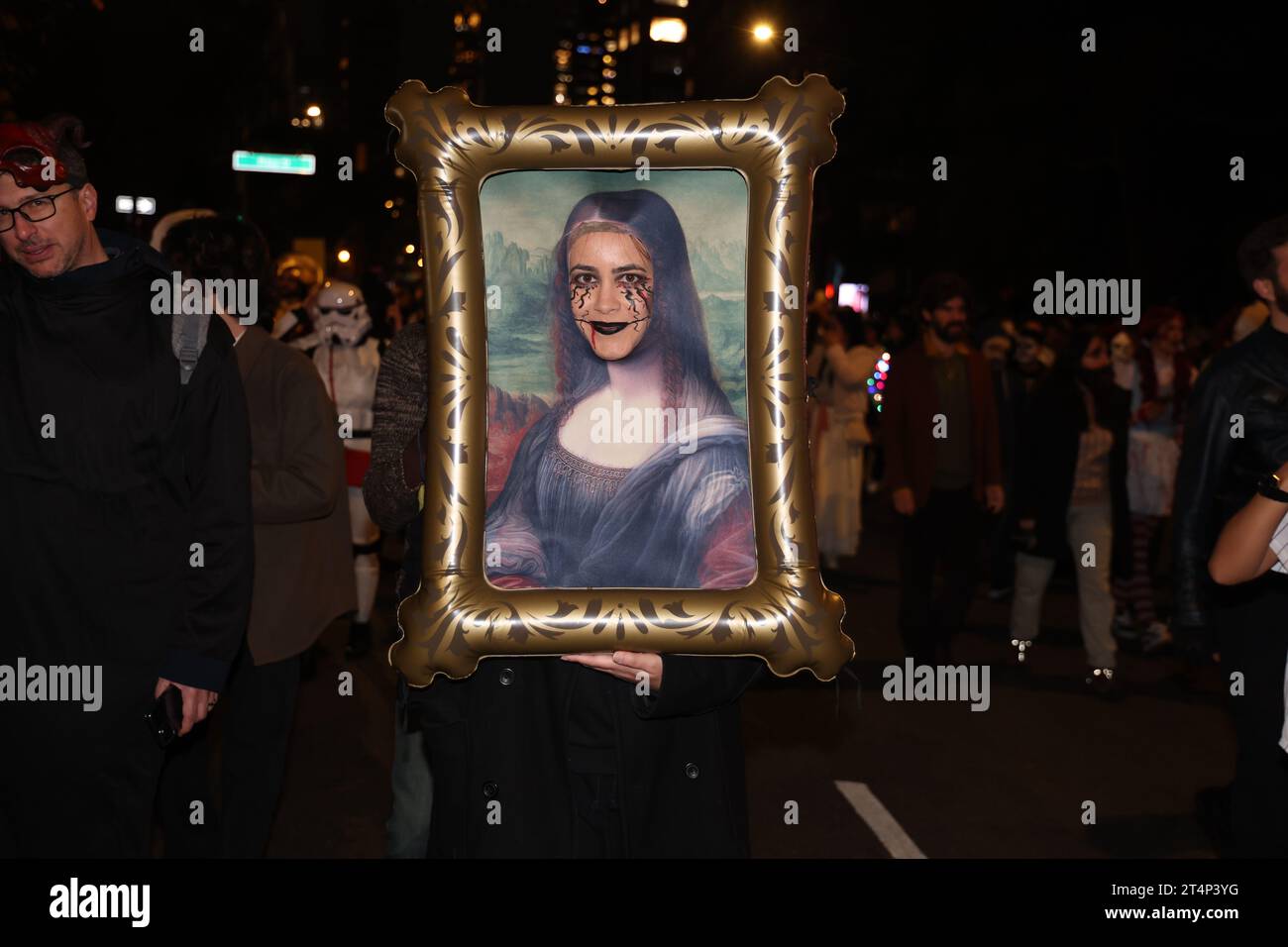 A woman dressed as a painting of Mona Lisa marches during the New York ...