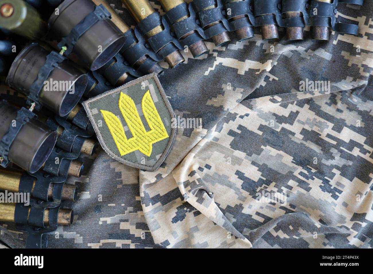 Ukrainian army symbol on machine gun belt lies on ukrainian pixeled ...