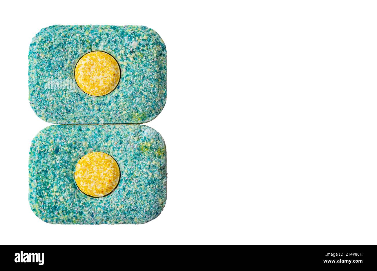 two solid tablets for washing dishes in a dishwasher on a white ...