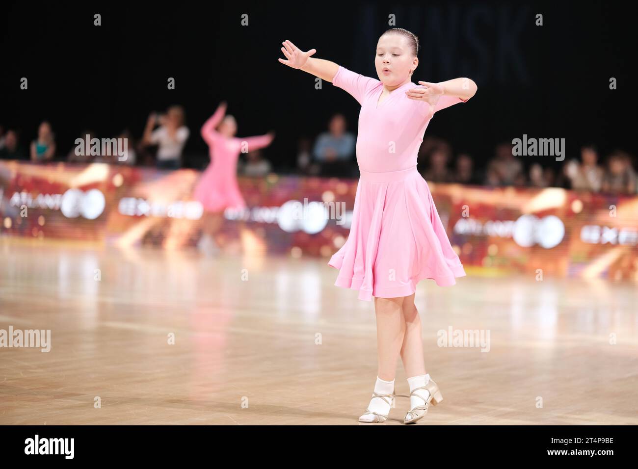 Behind the dancer - a girl dancer-athlete in a pale pink dress against ...