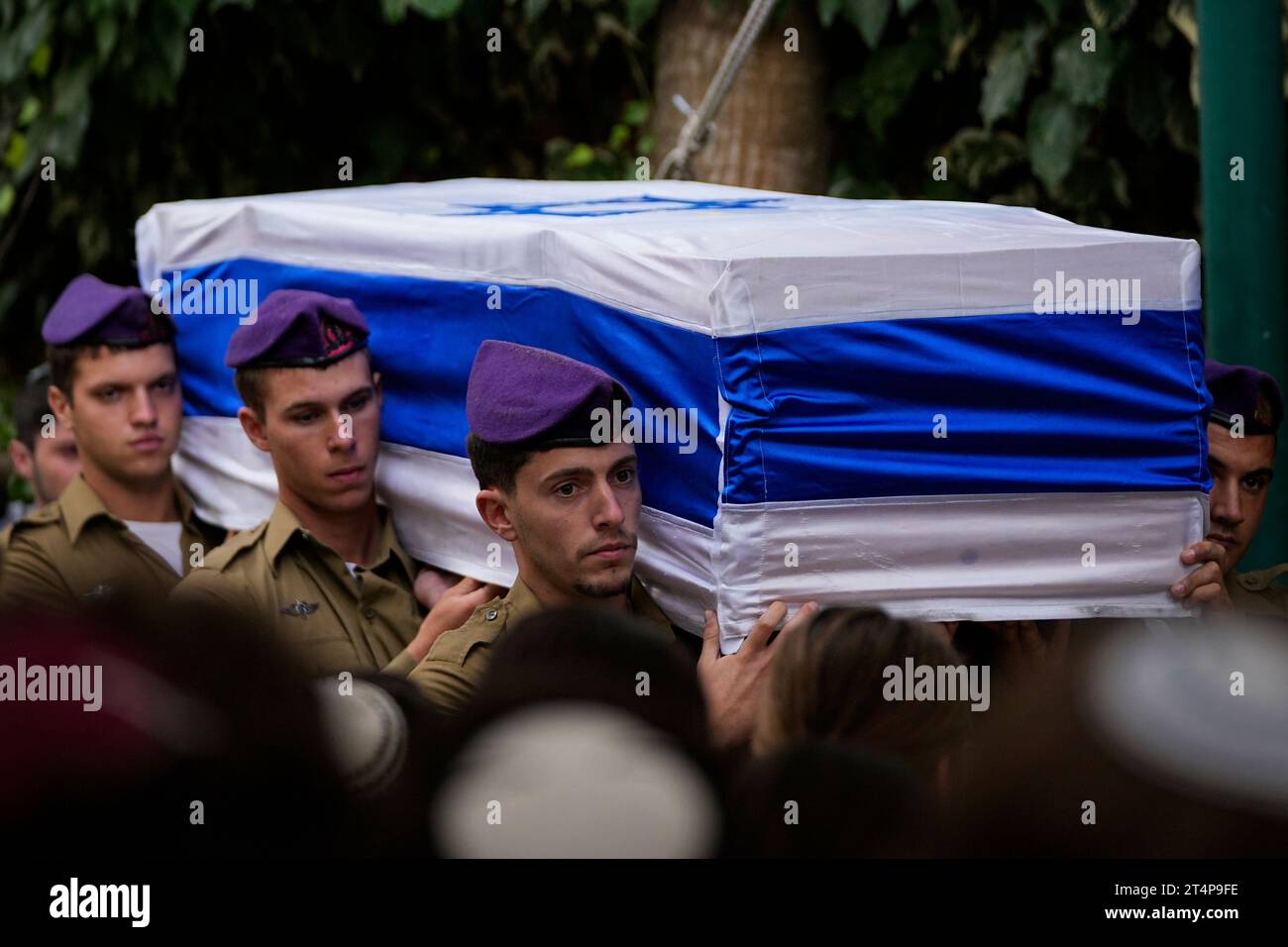 Israeli soldiers carry the flag-draped casket of Staff Sgt. Lavi ...