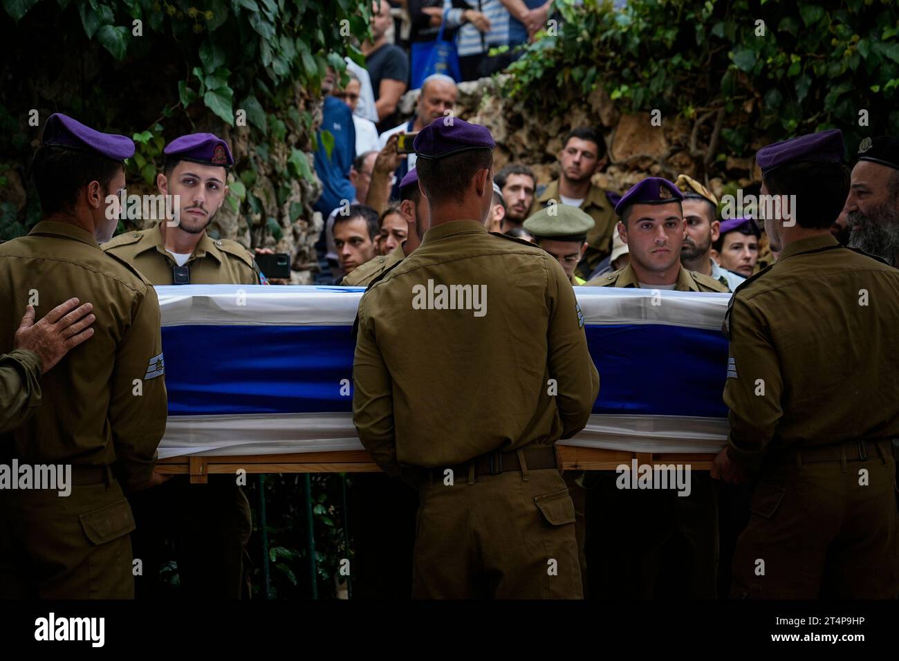 Israeli soldiers carry the flag-draped casket of Staff Sgt. Lavi ...