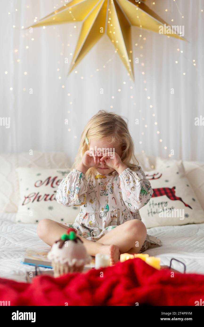Little blond toddler child, girl, crying in bed, not having gift for ...