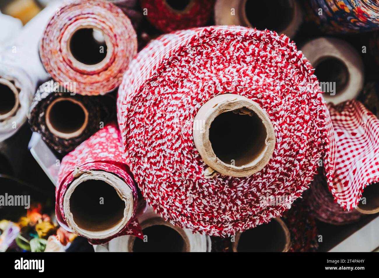 Rolls of fabric with colorful patterns - Sewing equipment Stock Photo ...