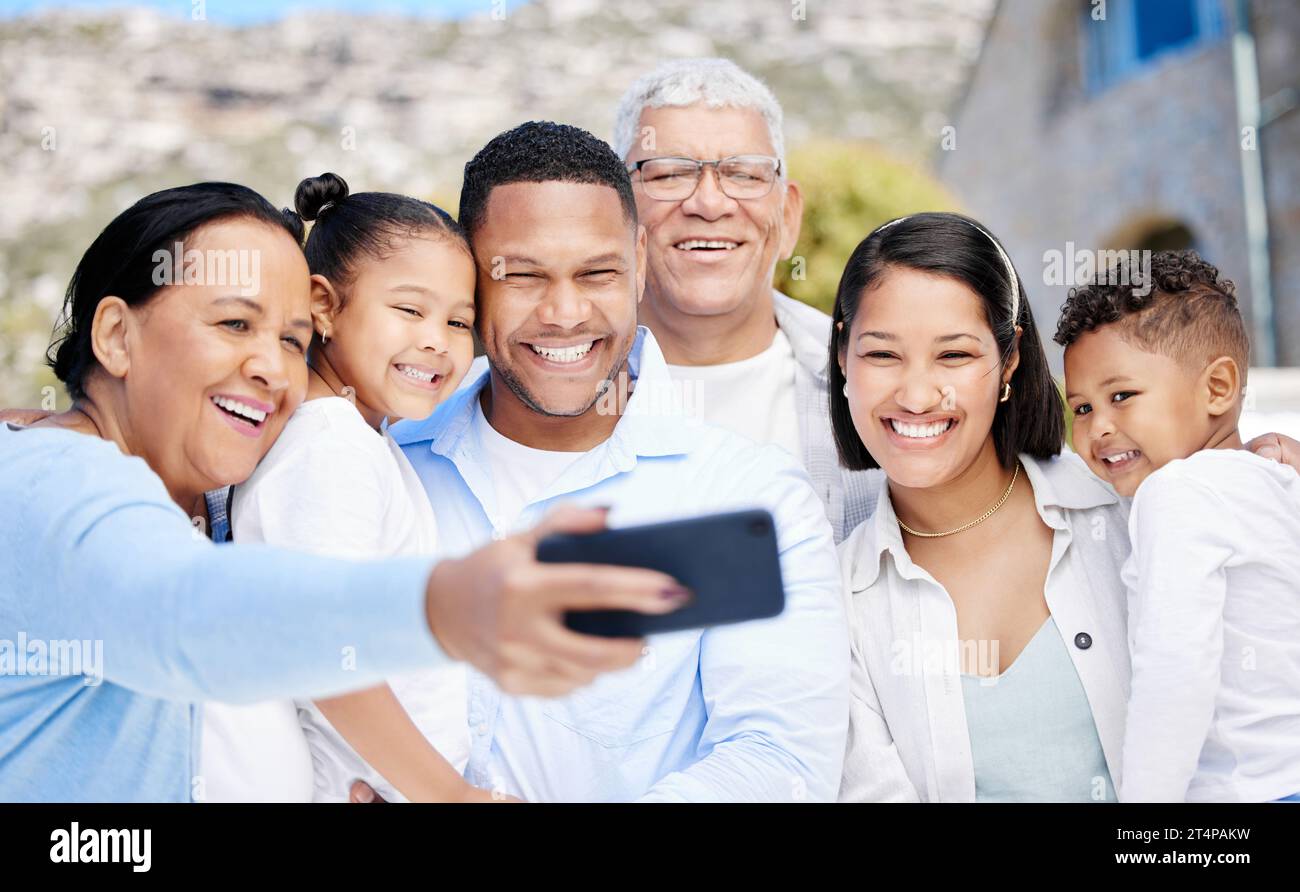 Everyone, squeeze in. a beautiful family taking a selfie together while ...