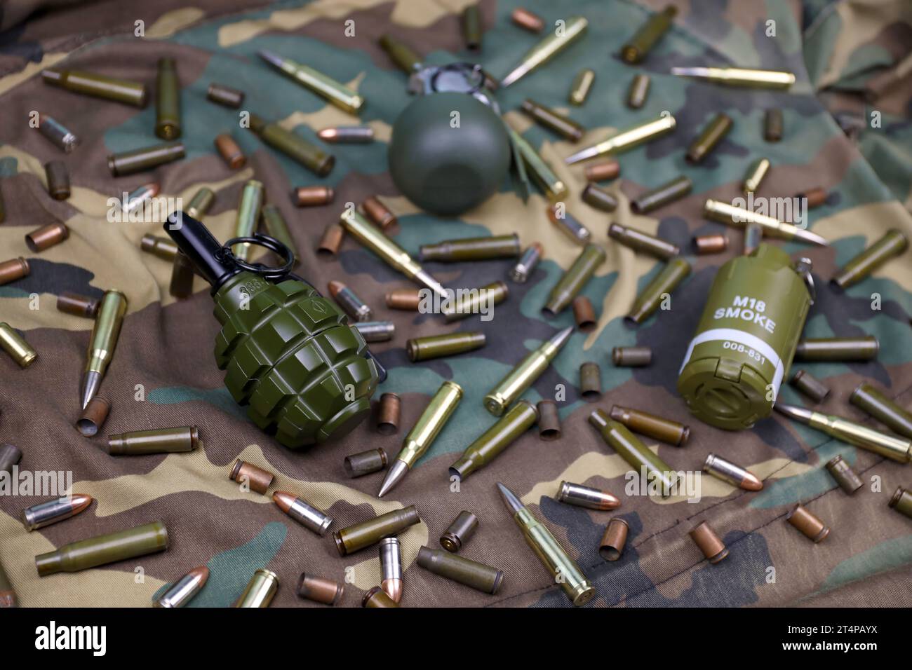 Different types of ammunition and grenades on a camouflage background ...