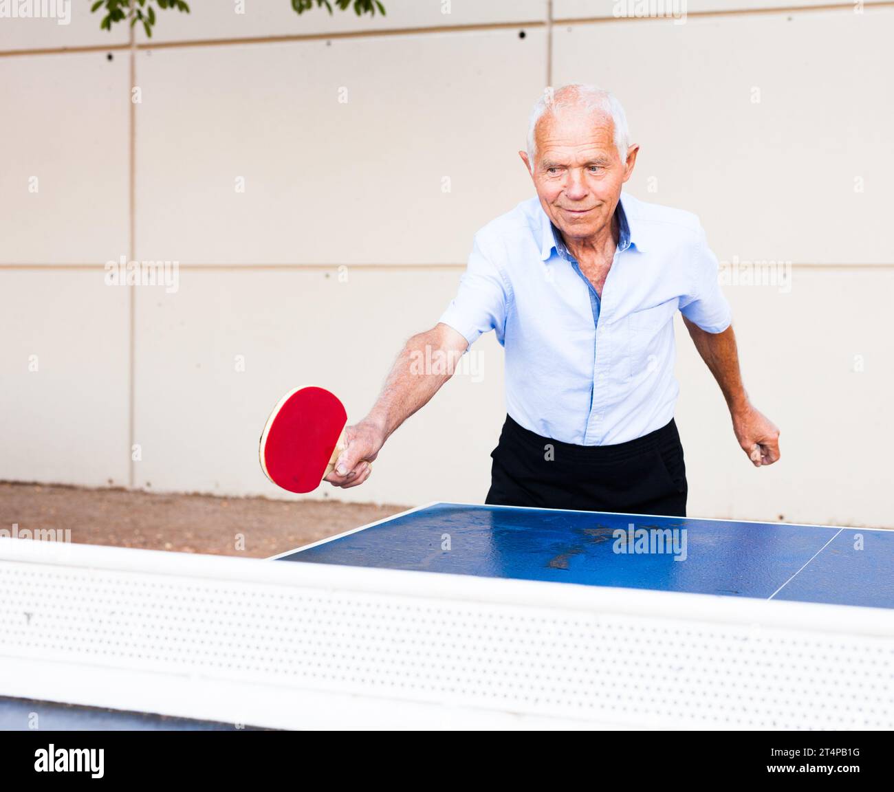 Mature man playing table tennis Stock Photo - Alamy