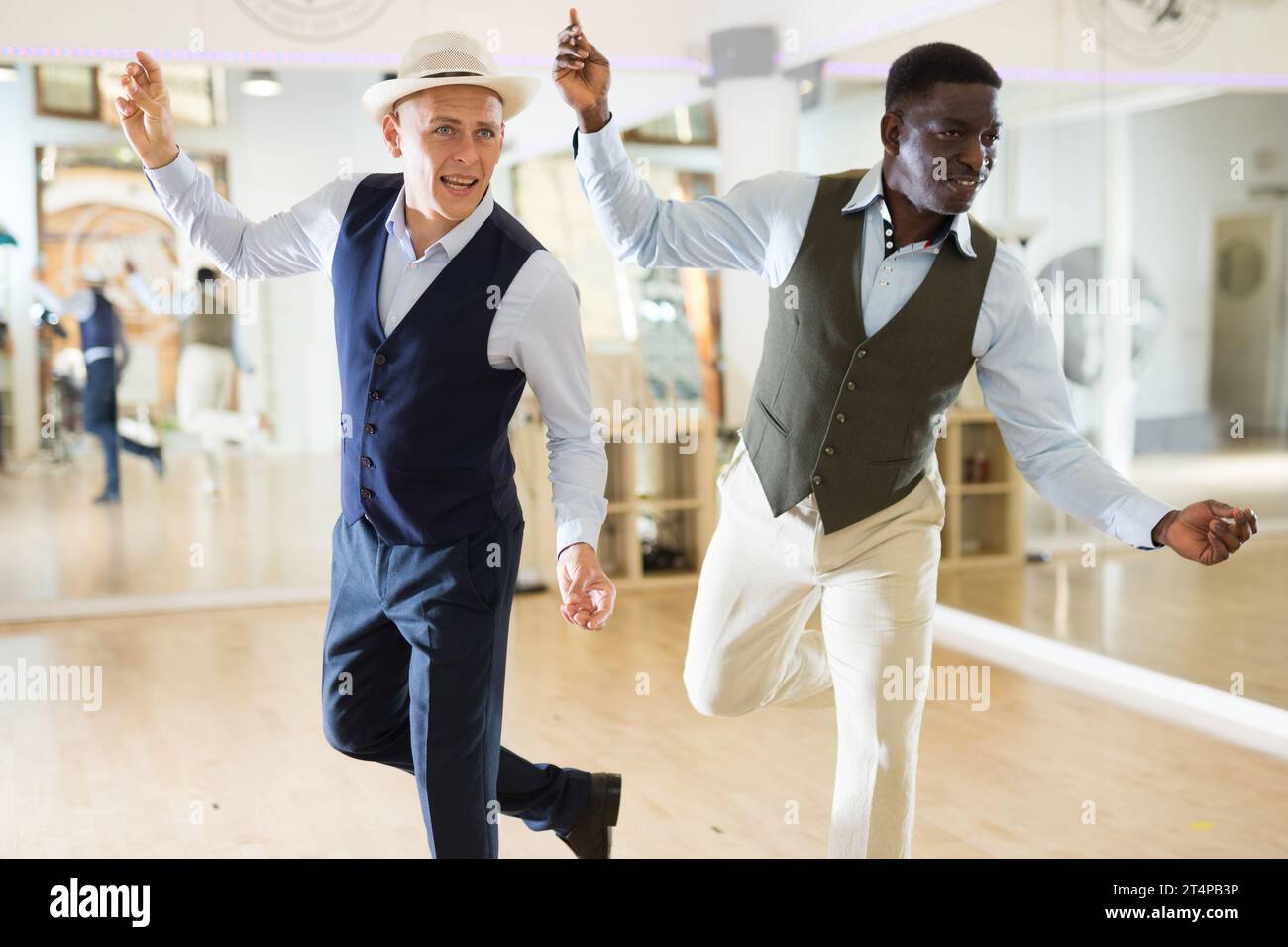 African-american and caucasian men dancing swing Stock Photo - Alamy