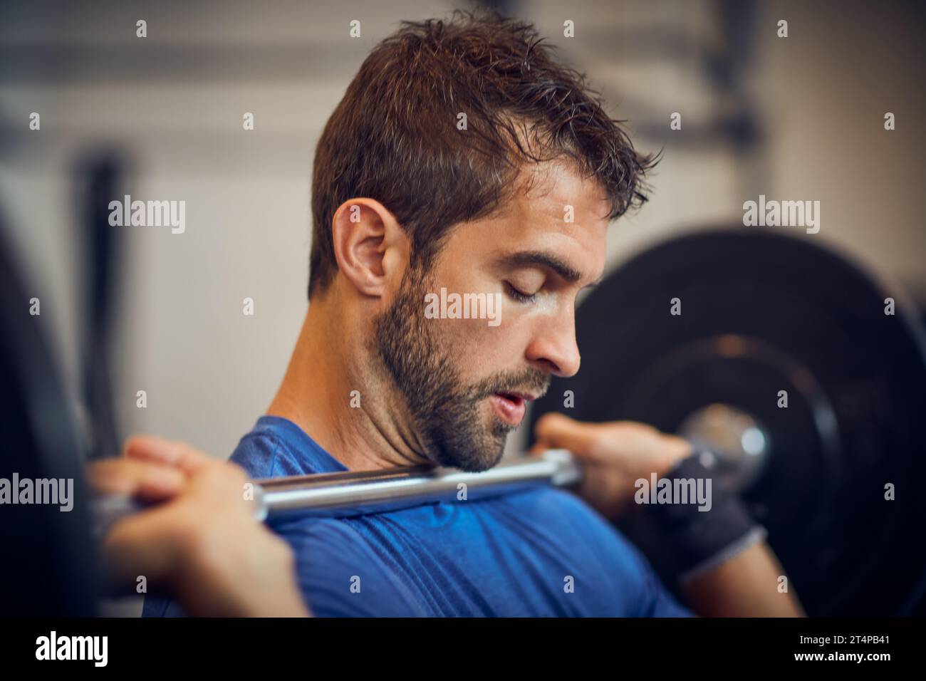 Train insane or remain the same. a handsome young man lifting weights ...