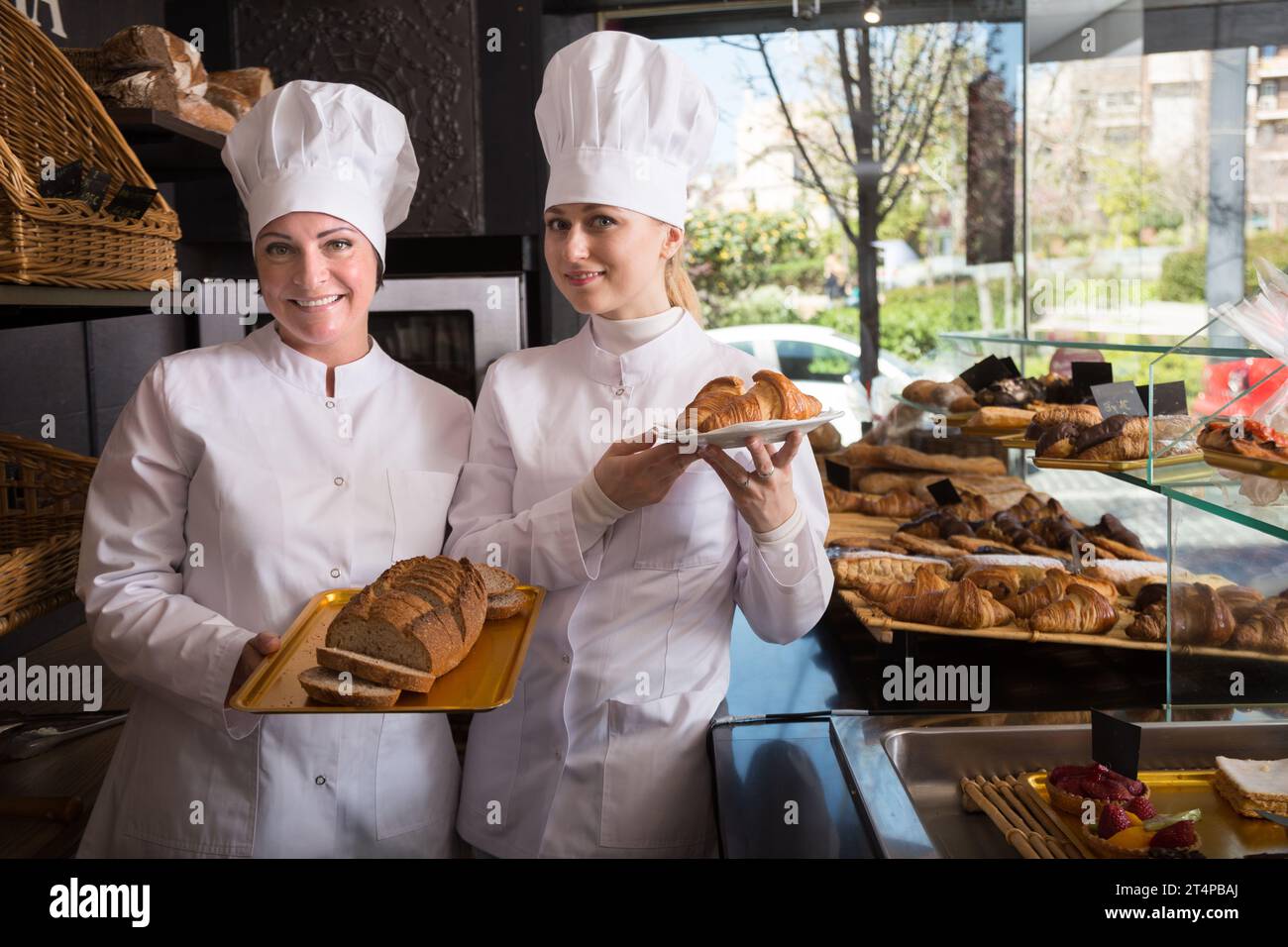 Women workers in a bakery posing with pastries Stock Photo - Alamy