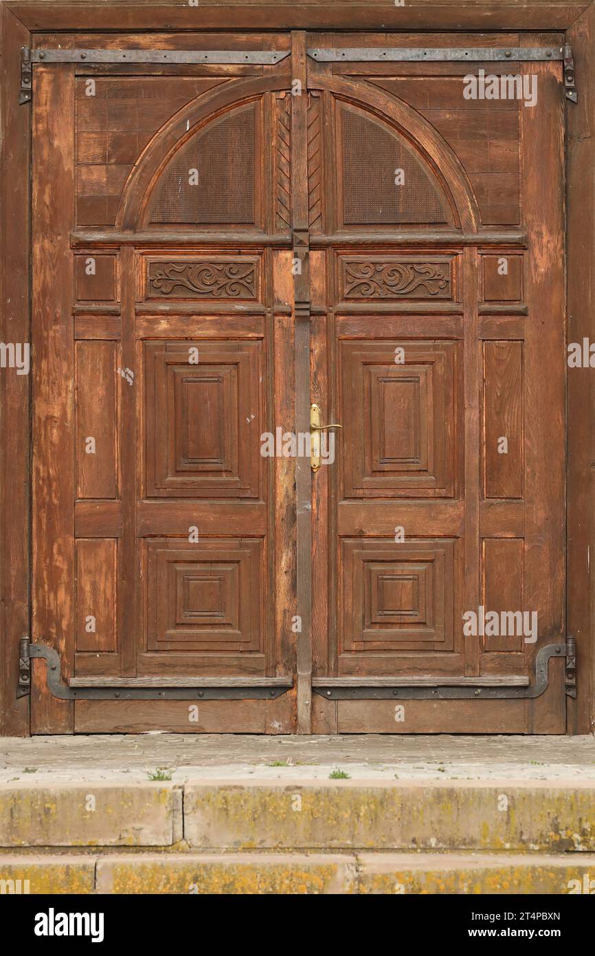 Very old solid wooden door in retro 19th century design close up ...