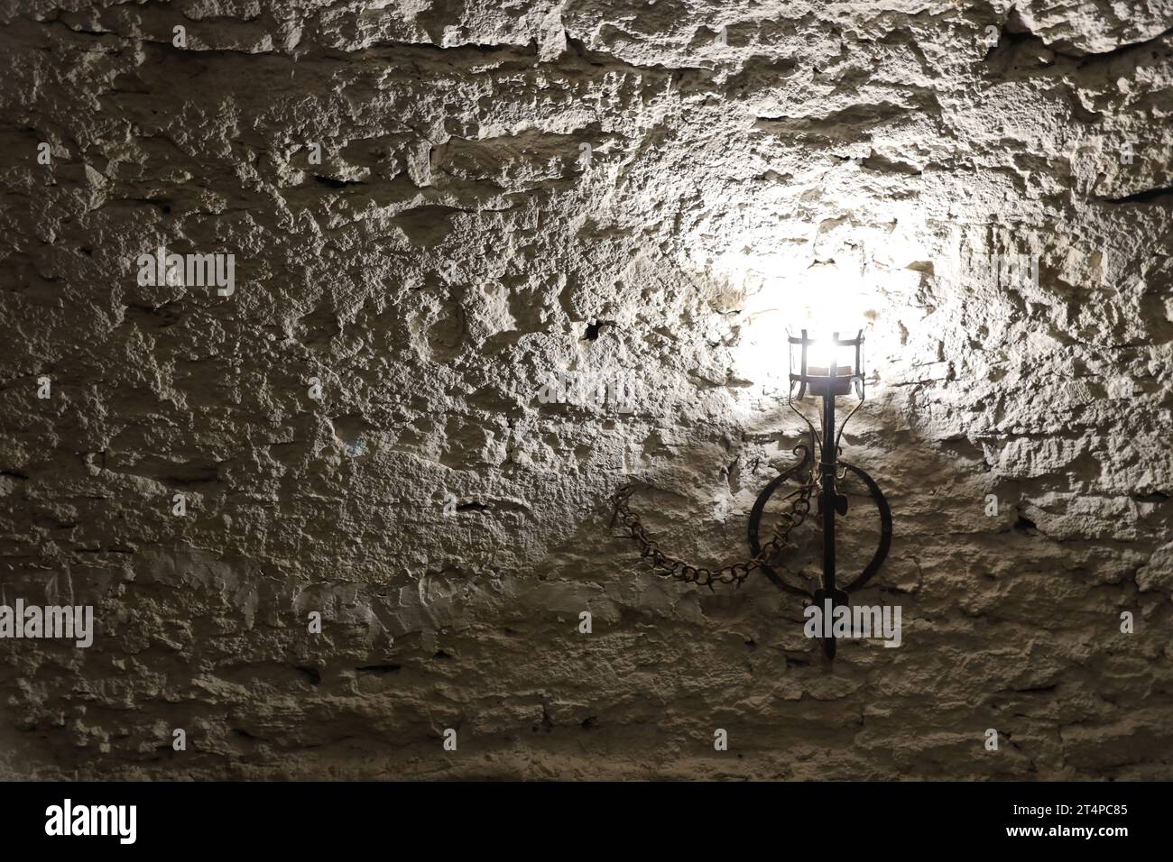 Lighted medieval castle torch hanging on a stone wall, vintage objects ...