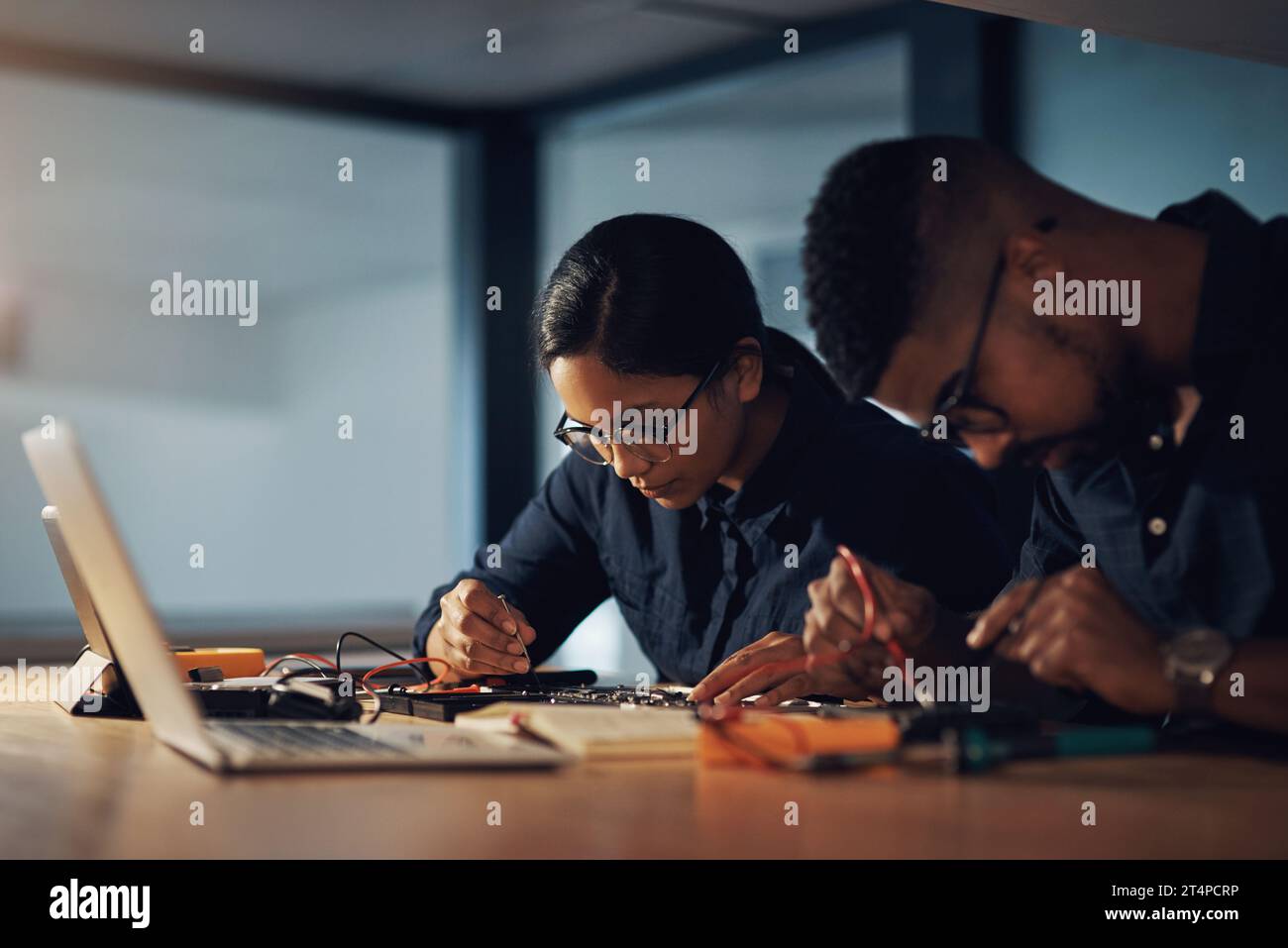 Combined expertise gets the computer repaired quicker. two young ...