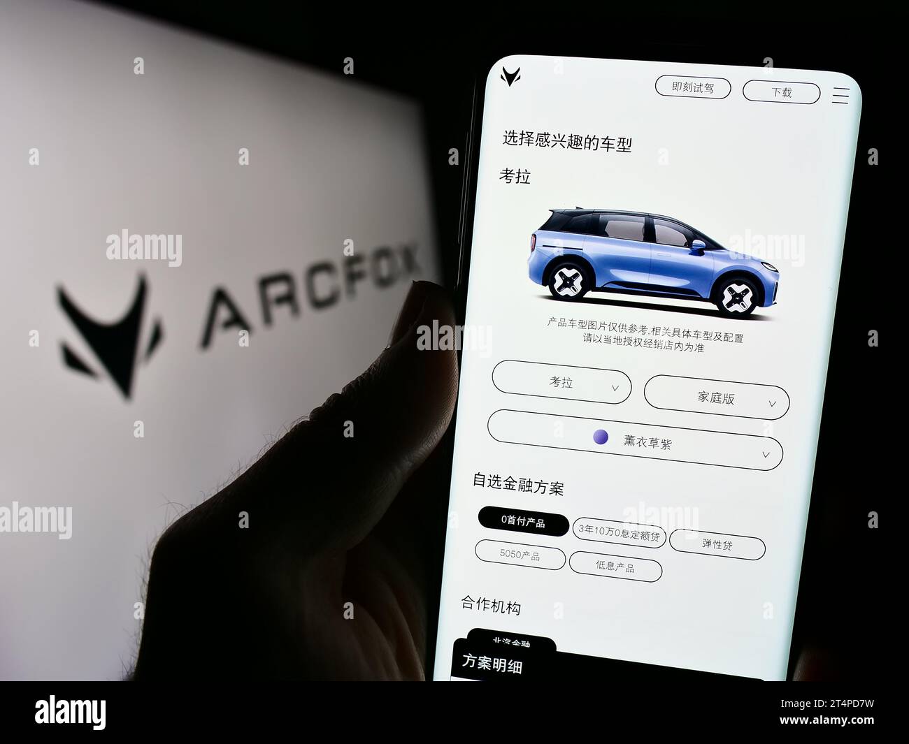 Person holding smartphone with website of Chinese electric vehicle company Arcfox in front of ...