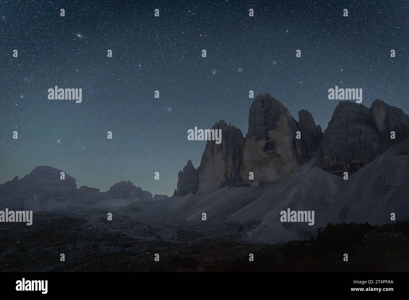 Night sky above massive rock formation, Tre Cime mountains, Dolomites ...