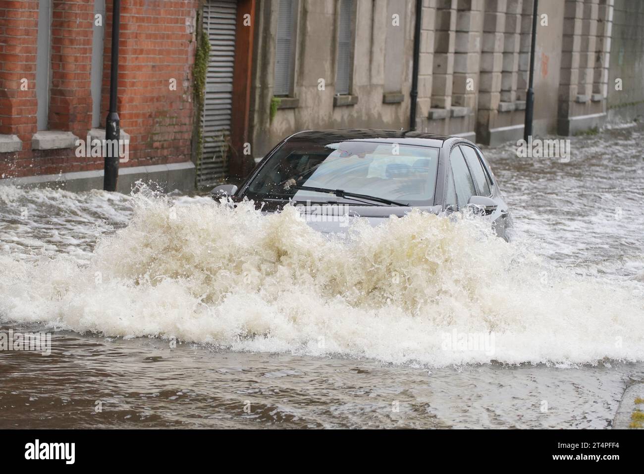 A car drives through flood water on Canal Quay in Newry Town, Co Down ...