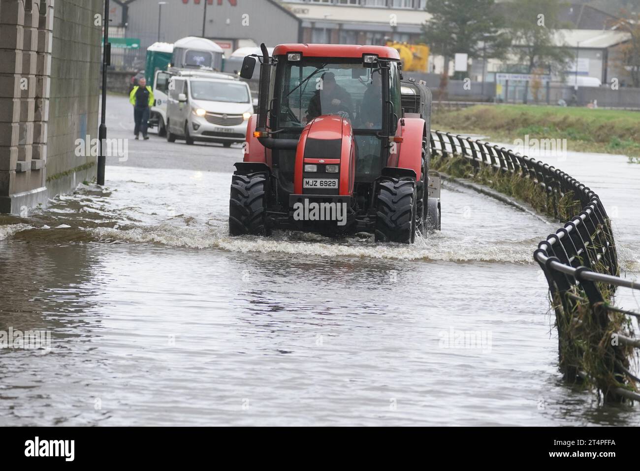 A tractor makes its way through flood water in Canal Quay in Newry Town ...