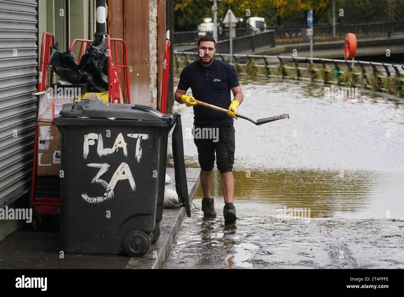 Ross Campbell, sales assistant at Vivo, clears out damaged property in ...