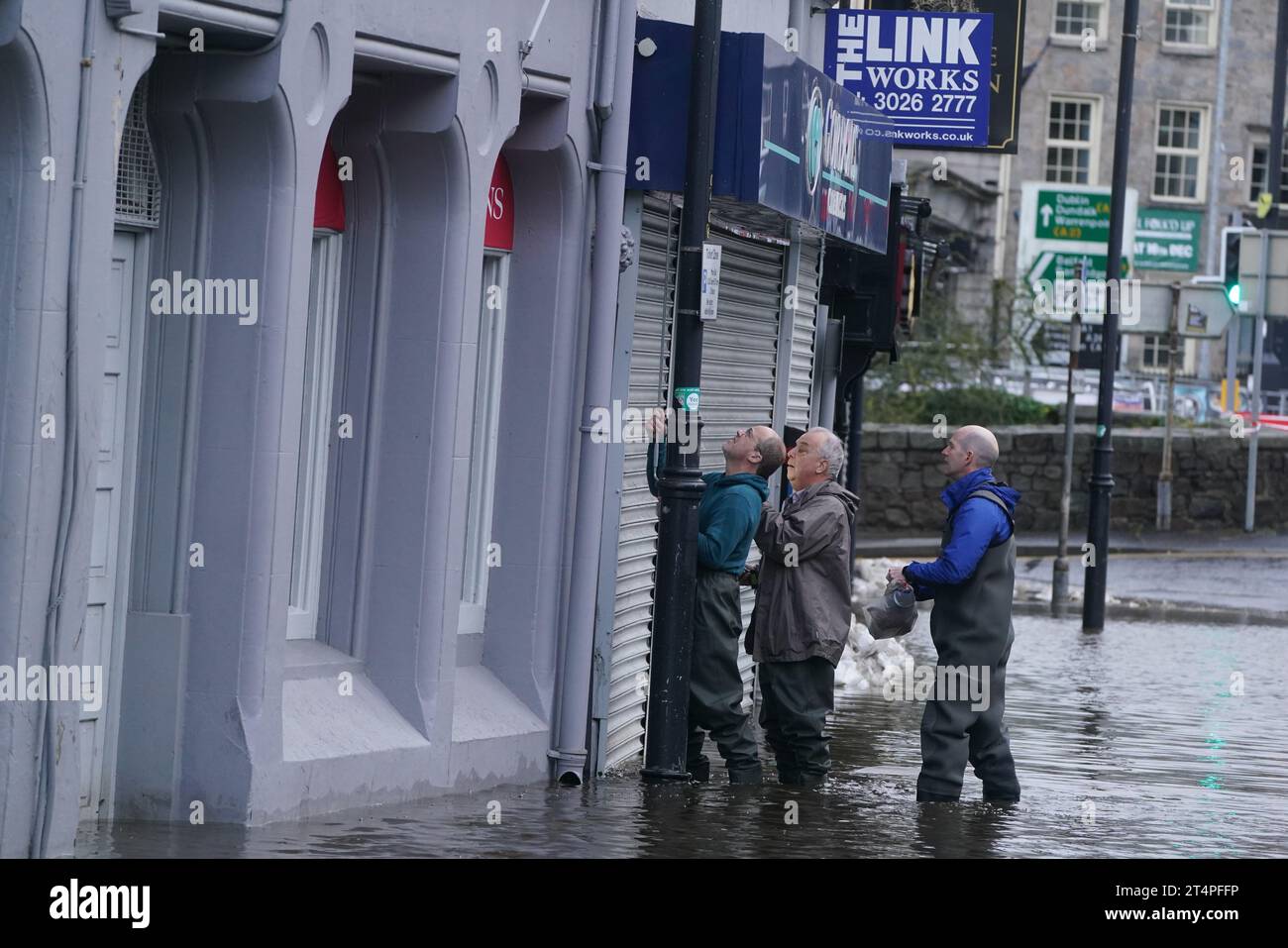 People walk through flood water in Sugar Island, Newry Town, Co Down ...