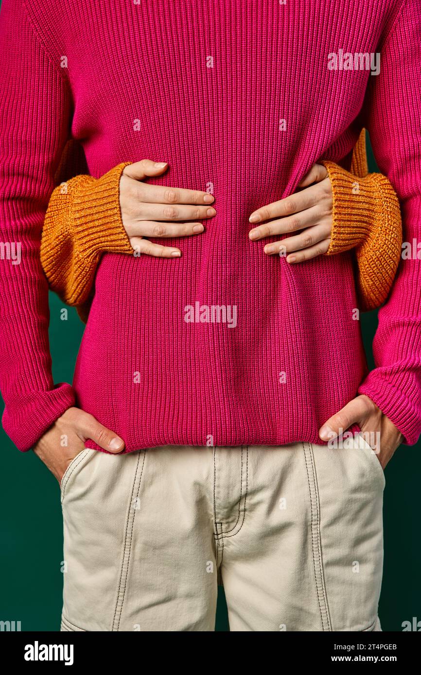 partial view of woman hugging boyfriend in pink knitted sweater, hands ...