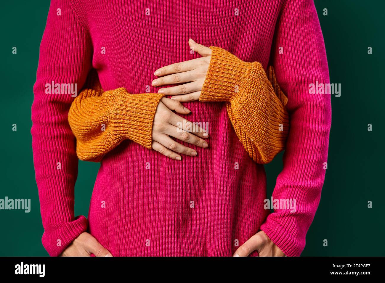 cropped view of woman hugging boyfriend in pink knitted sweater, hands ...