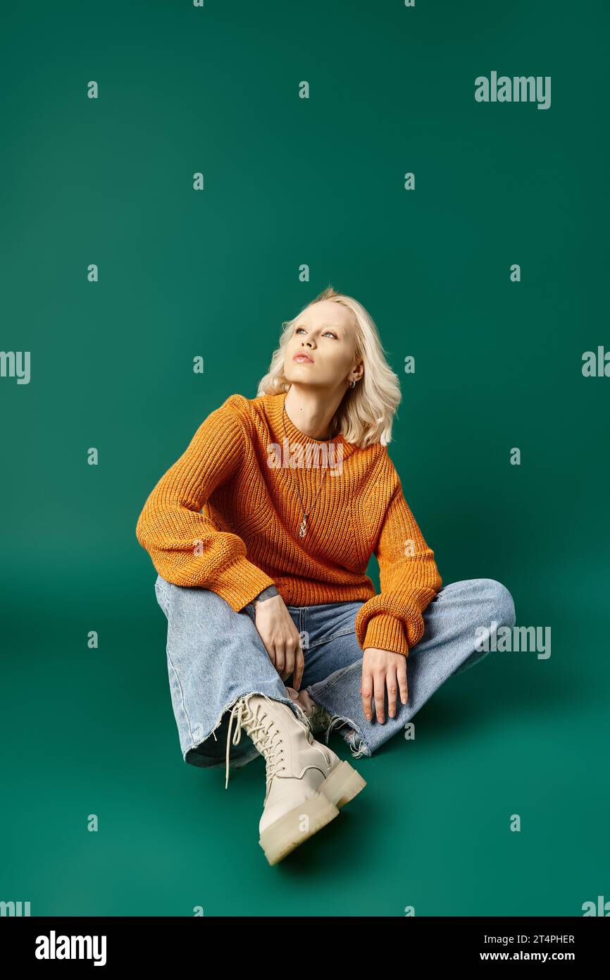 dreamy woman in mustard yellow sweater and comfy denim jeans sitting on ...